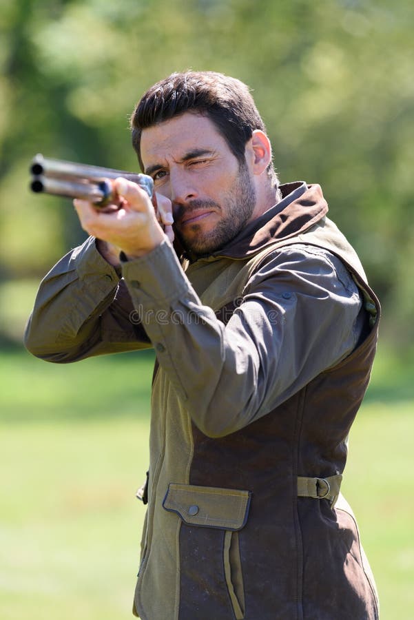 Portrait Hunter Pointing Gun Outdoors Stock Image - Image of rough ...