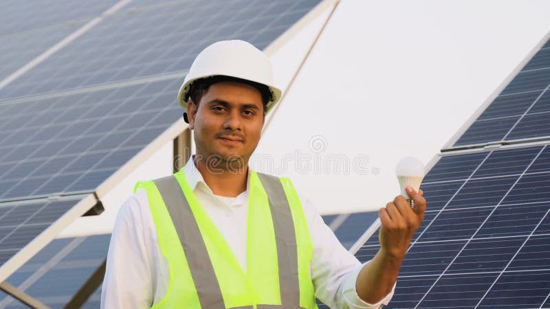 Portrait of Indian Engineer with Lamp on Solar Panels Power Farm Stock ...