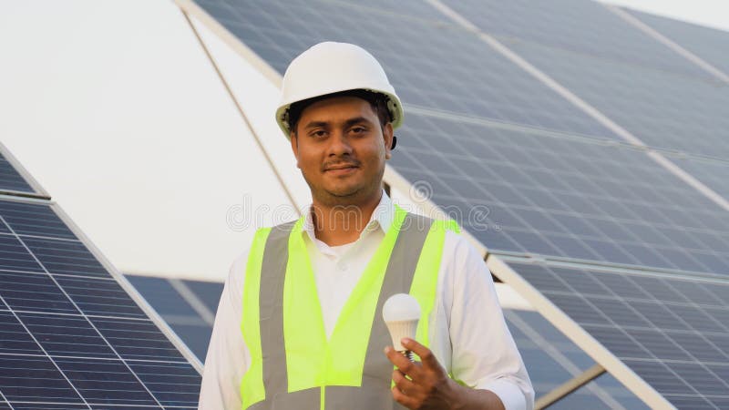 Indian Engineer at Solar Farm with Energy Flow Animation Looking at ...