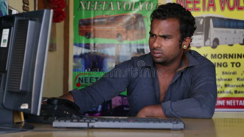 Portrait of Indian Man Sitting by a Counter and Working on Computer ...