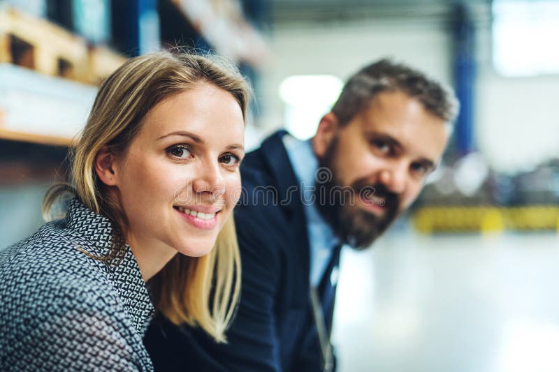 A Portrait Of An Industrial Man And Woman Engineer In A Factory