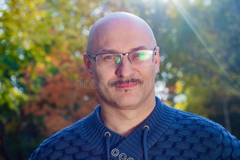 Portrait of an Intelligent Bald Man with Glasses in a Park Stock Image ...