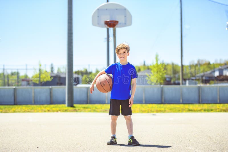 Portrait of a Kid Boy Playing with a Basketball in Park Stock Image ...