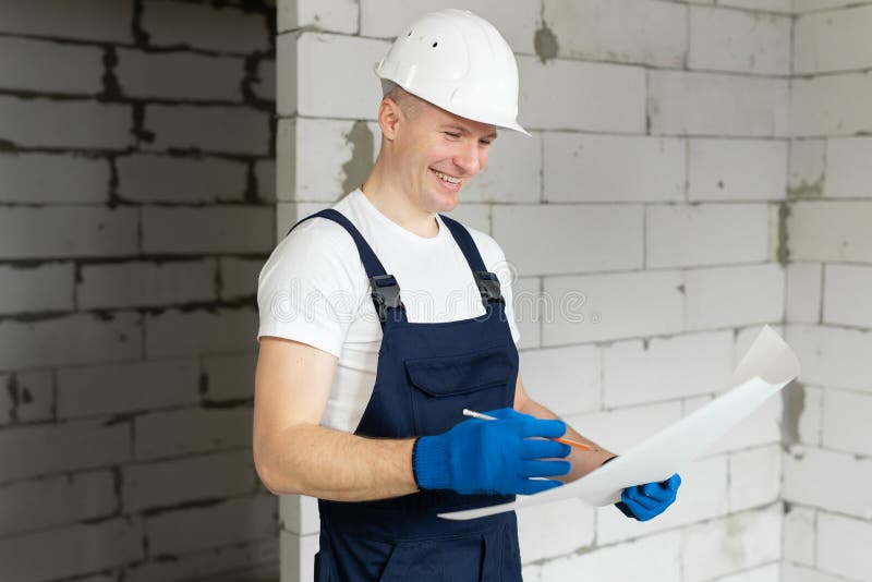 Portrait of a Laughing Architect-builder Studying the Floor Plan. Stock ... Portrait of a Laughing Architect-builder Studying the Floor Plan. Stock ...
