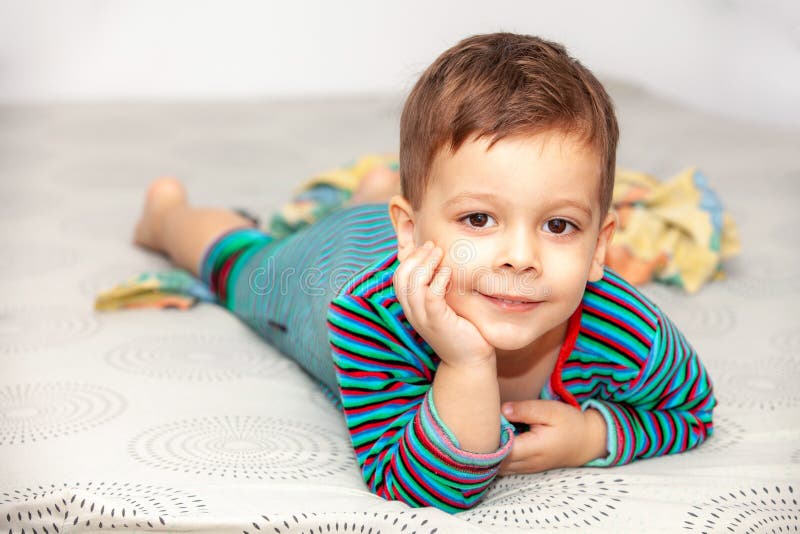 Portrait little boy on bed stock photo. Image of caucasian - 207643064
