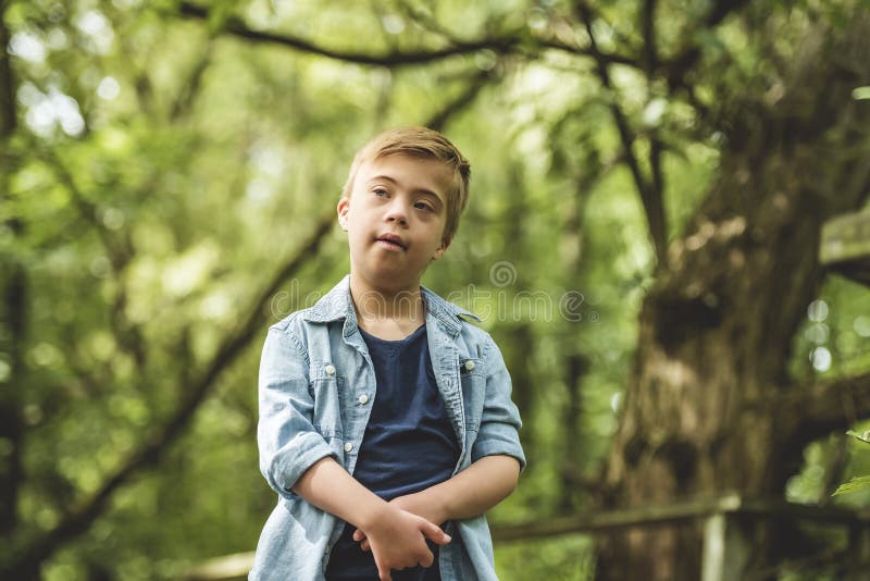 Portrait of a Little Boy with Down Syndrome while Playing in a Park ...