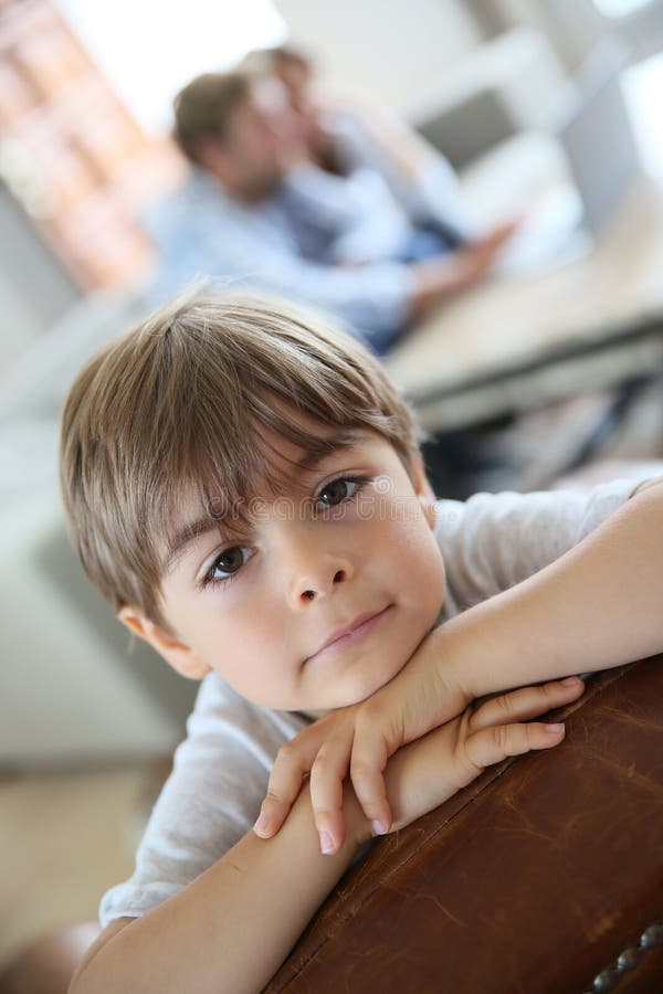Portrait of Little Boy Looking at Camera, Parents in the Back Stock ...