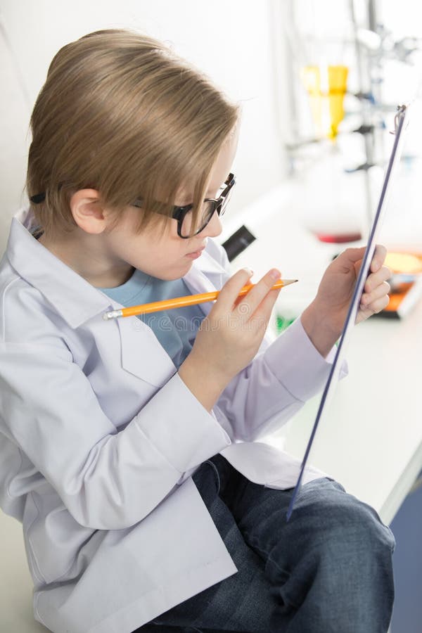 Portrait of Little Boy Scientist Making Notes in Clipboard Stock Photo ...
