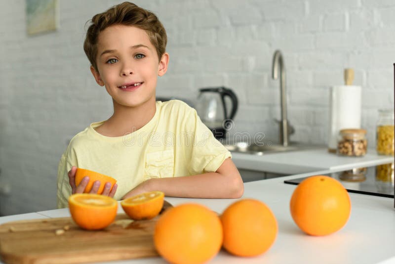Portrait of Little Boy Standing at Counter with Fresh Oranges in ...