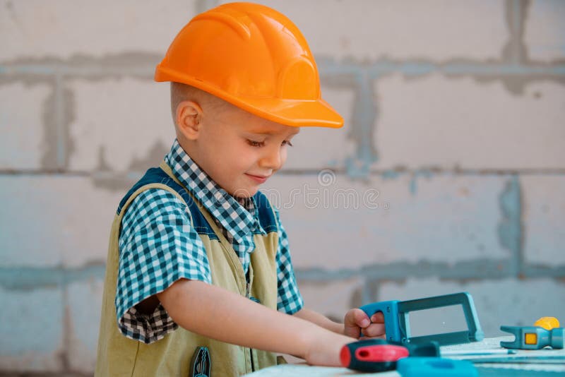 Portrait of Little Builder in Hardhats with Instruments for Renovation ...