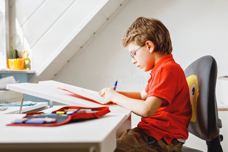 Portrait of Little Kid Boy with Glasses at Home Making Homework ...