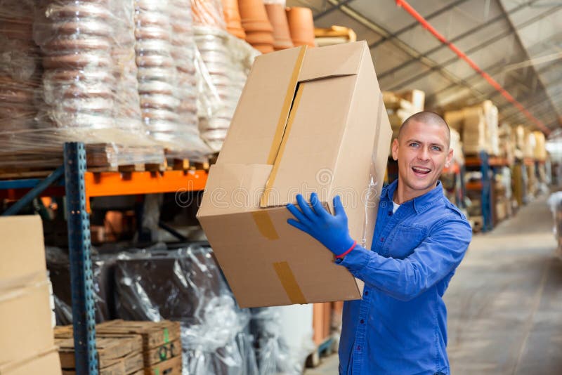 Portrait of Loader with a Large Box in His Hands in Store Warehouse ...