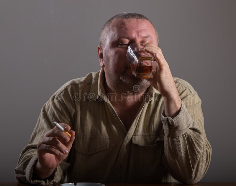 Portrait of a Lonely, Desperate Man Drinking Alcohol and Smoking ...