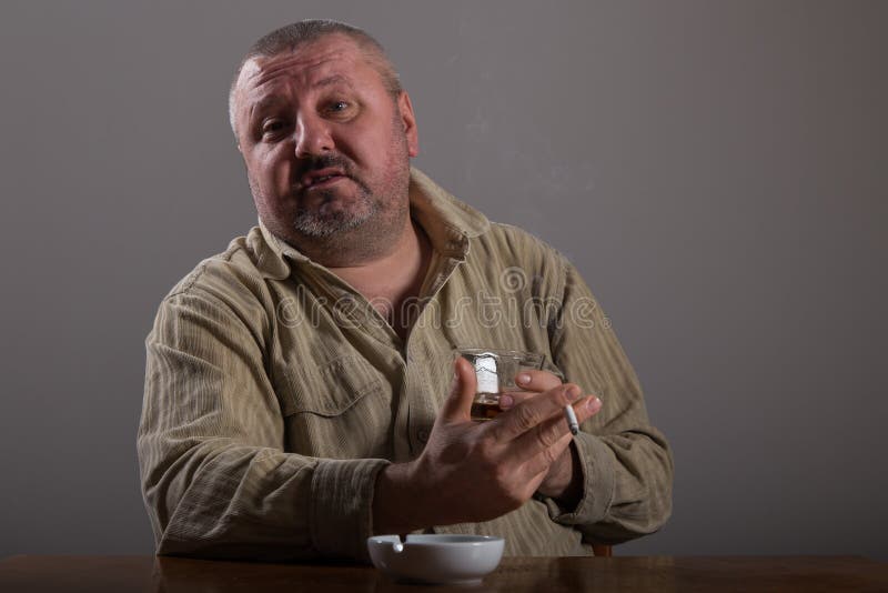 Portrait of a Lonely, Desperate Man Drinking Alcohol and Smoking ...