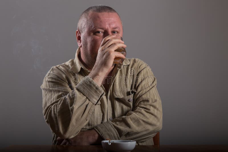Portrait of a Lonely, Desperate Man Drinking Alcohol and Smoking ...