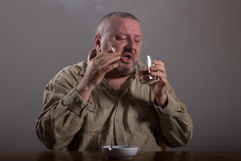 Portrait of a Lonely, Desperate Man Drinking Alcohol and Smoking ...