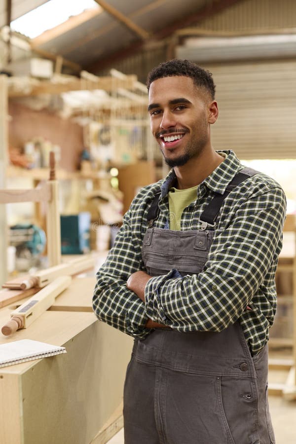 Portrait of Male Apprentice Working As Carpenter in Furniture Workshop ...