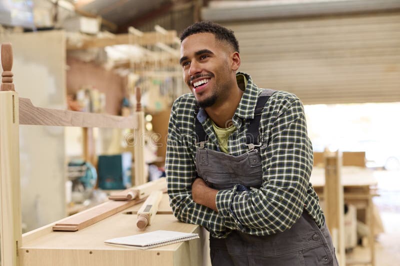 Portrait of Male Apprentice Working As Carpenter in Furniture Workshop ...