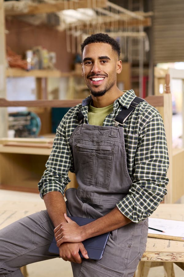 Portrait of Male Apprentice Working As Carpenter in Furniture Workshop ...