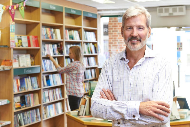 Portrait of Male Bookstore Owner with Customer in Background Stock ...