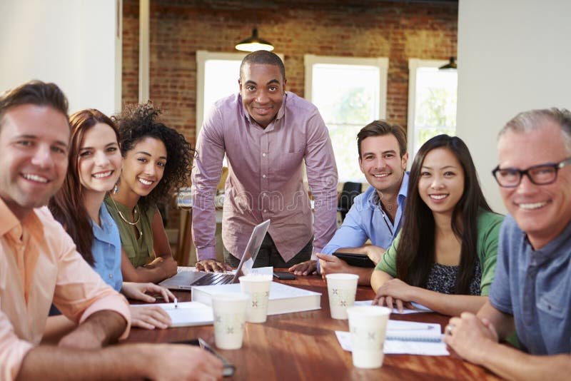 Male Boss Addressing Meeting Around Boardroom Tabl Stock Image - Image ...