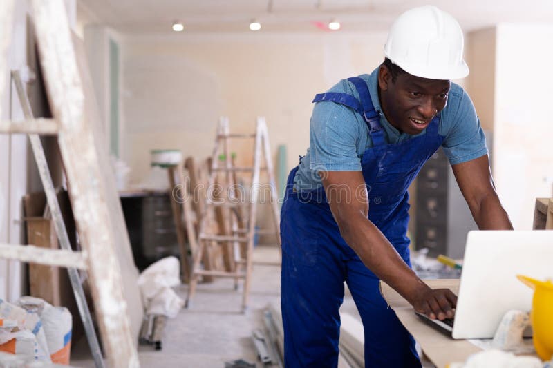 Portrait of a Male Builder Who Checks Work Done Using a Laptop Stock ...
