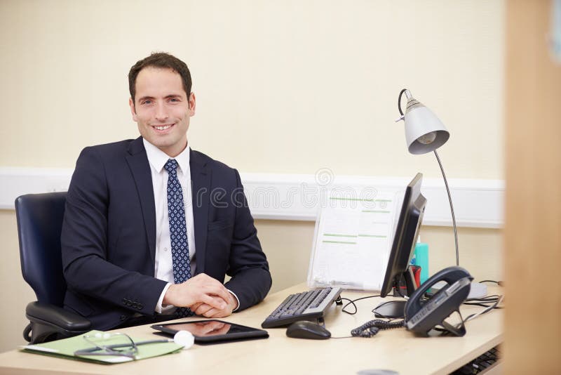 Portrait of Male Consultant Working at Desk in Office Stock Photo ...