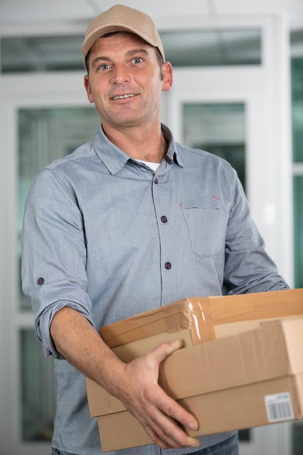 Portrait Male Courier Holding Parcels Stock Image - Image of delivered ...