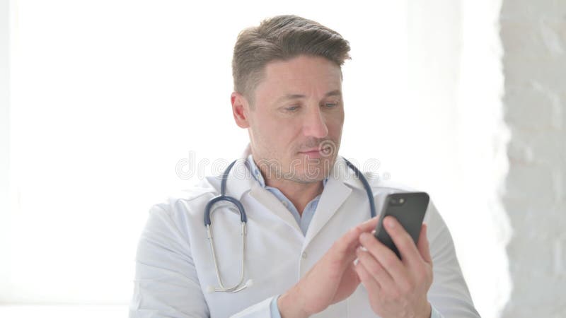 Portrait of Male Doctor Browsing Internet on Smartphone Stock Image ...
