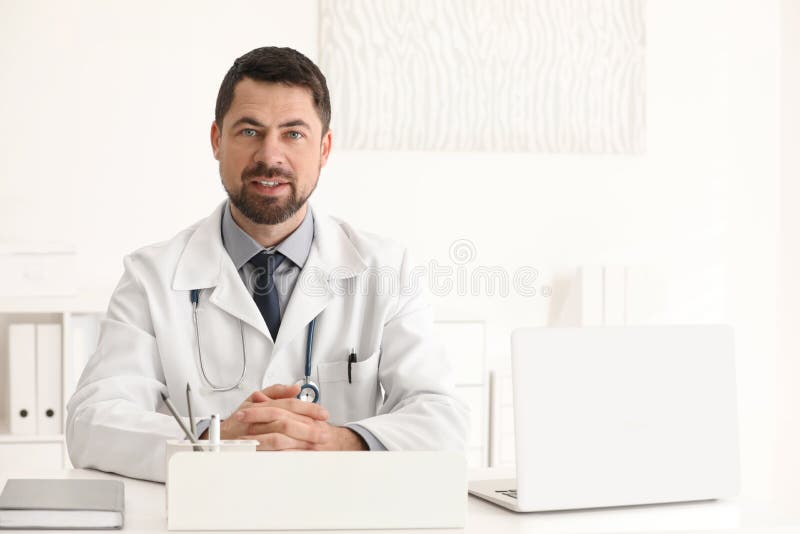 Portrait of Male Doctor in Coat at Workplace Stock Photo - Image of ...