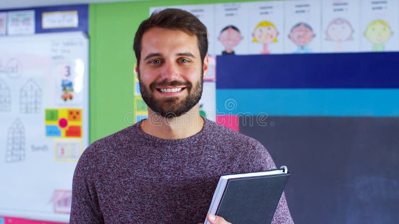 Portrait of Male Elementary School Teacher Standing in Classroom ...