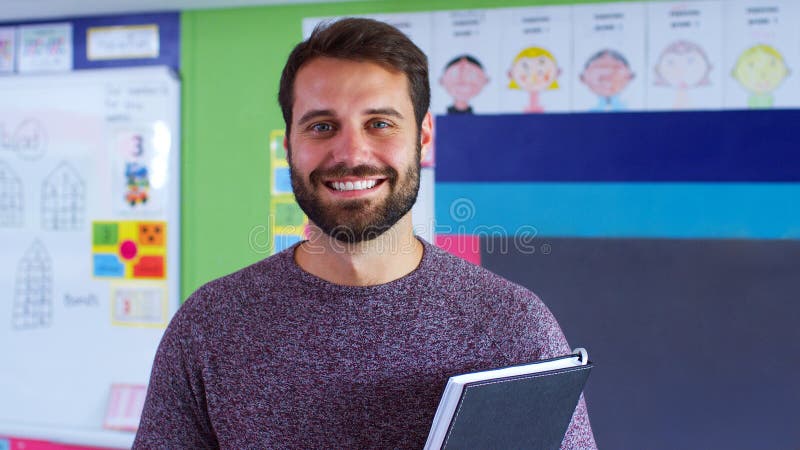 Portrait of Male Elementary School Teacher Standing in Classroom ...