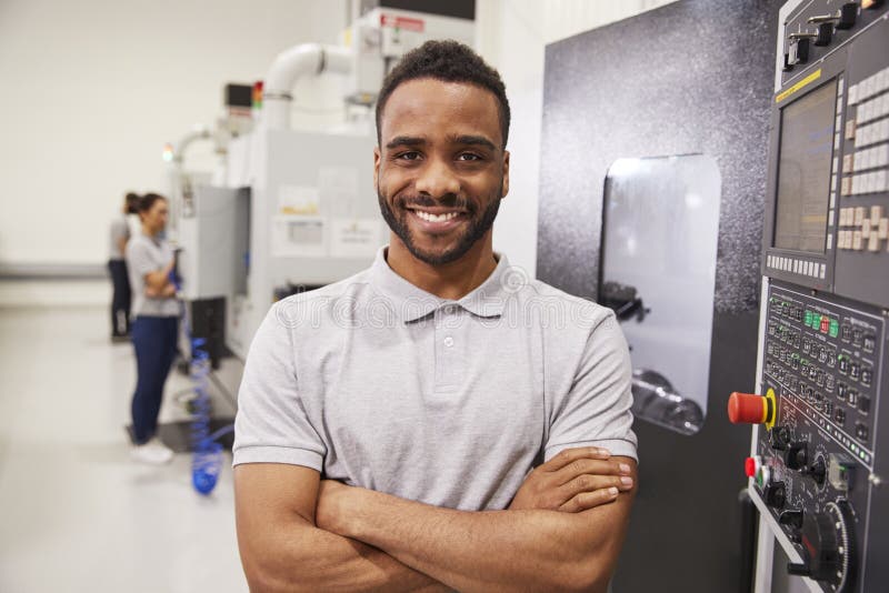 Portrait of Male Engineer Operating CNC Machinery in Factory Stock ... Portrait of Male Engineer Operating CNC Machinery in Factory Stock ...