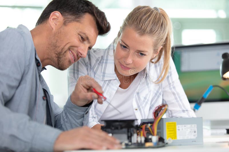 Portrait Male and Female Technician Repairing Computer Stock Image ...