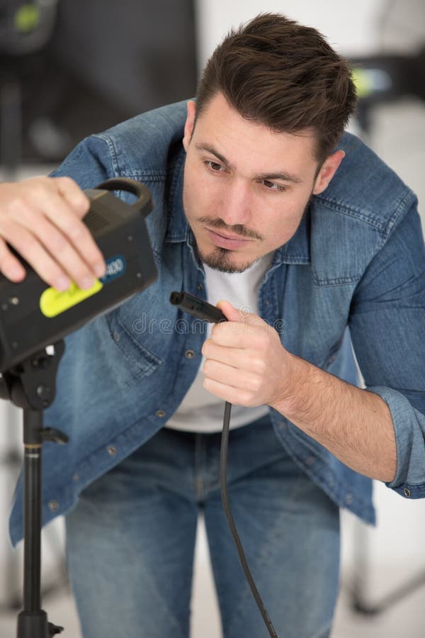 Portrait Male Photographer in Studio Plugging Flash Strobe Stock Image ...