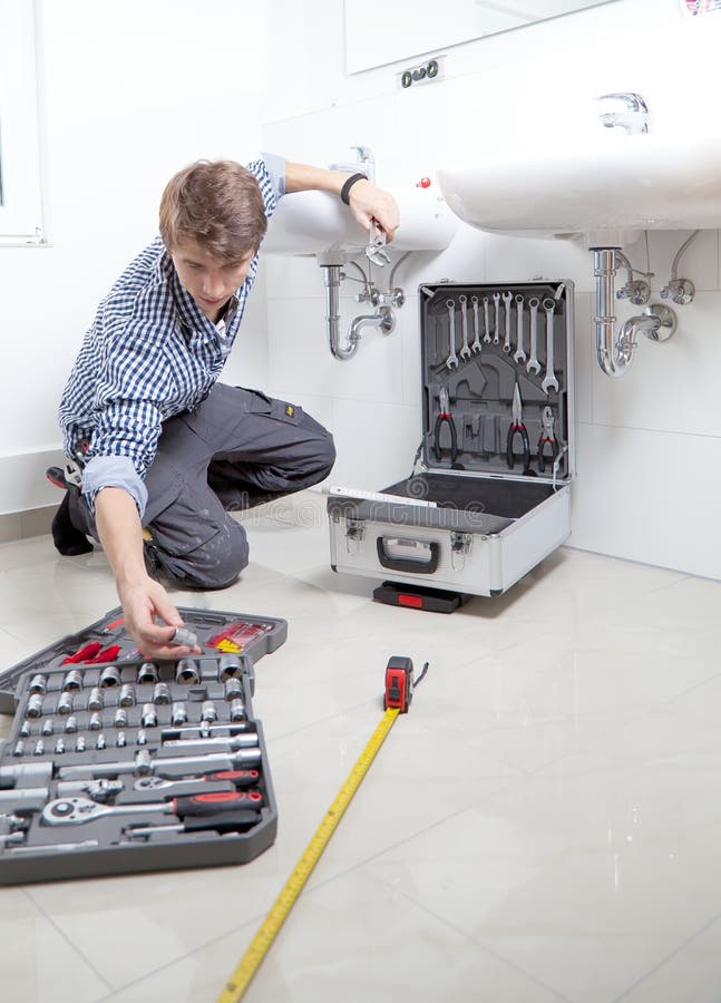 Portrait of Male Plumber Fixing a Sink in Bathroom Stock Image - Image ...