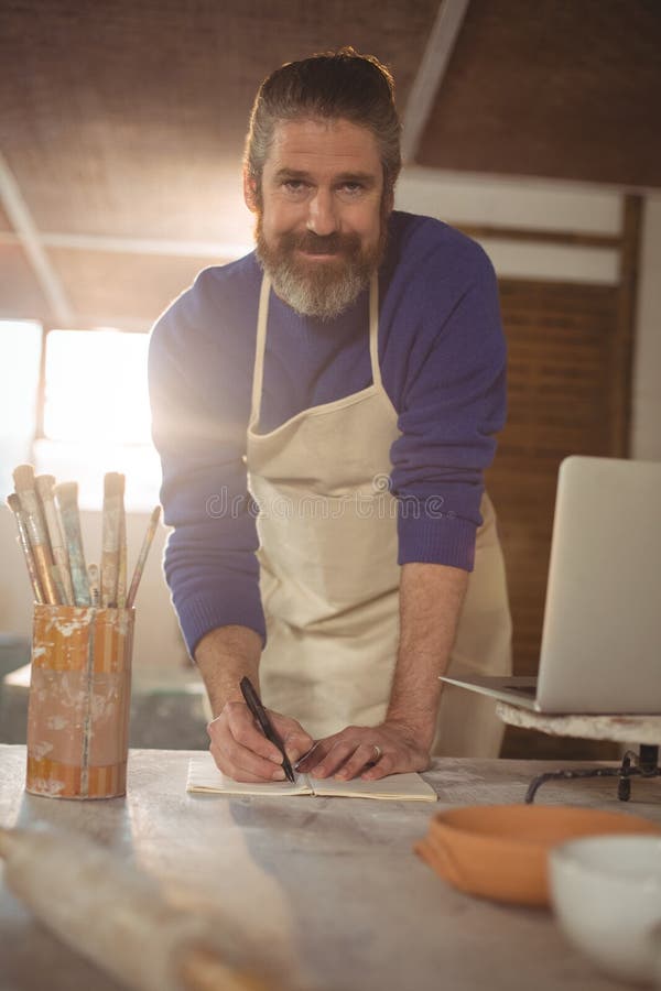 Portrait of Male Potter Writing in Book Stock Image - Image of ...
