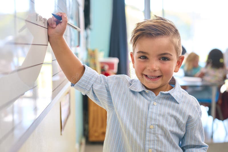 Portrait of Male Primary or Elementary School Student Writing on ...