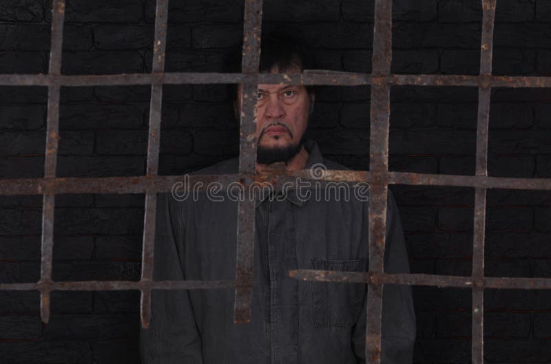 Portrait of a Male Prisoner Behind Bars in Prison Cell Stock Photo ...