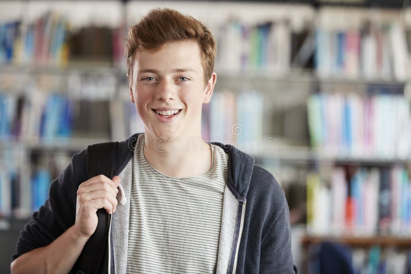 Portrait of Male Student Standing in College Library Stock Image ...