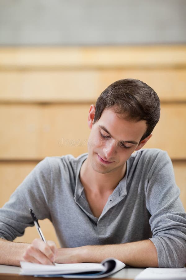 Portrait of a Male Student Writing on a Notepad Stock Image - Image of ...