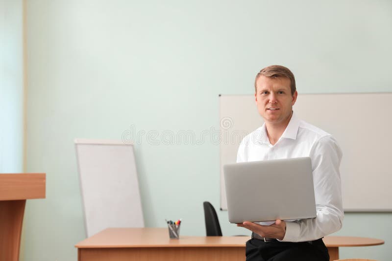 Portrait of Male Teacher with Laptop in Classroom Stock Image - Image ...
