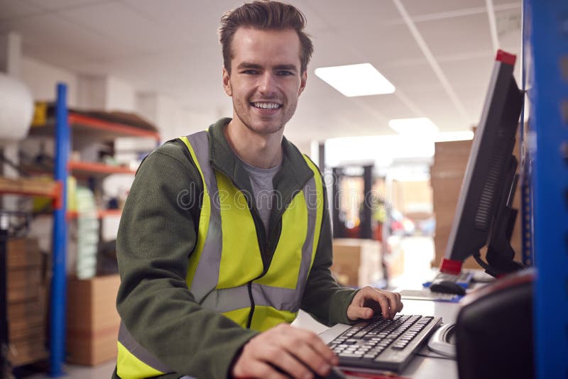 Portrait of Male Worker in Busy Modern Warehouse Working on Computer ...