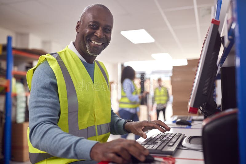 Portrait of Male Worker in Busy Modern Warehouse Working on Computer ...