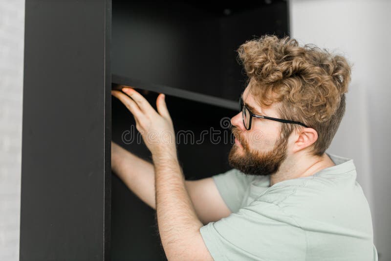 Portrait of Man Assembling Furniture. Do it Yourself Furniture Assembly ...