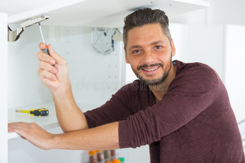 Portrait Man Assembling Kitchen Cupboard Stock Photo - Image of adjust ...