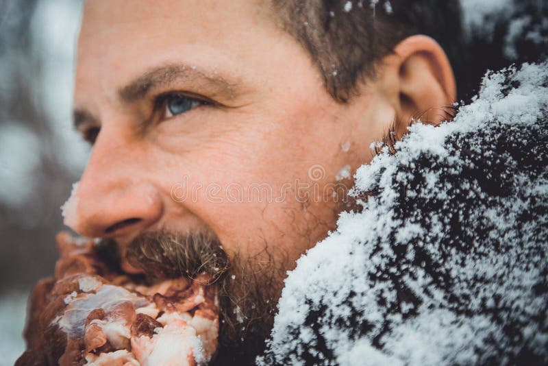 Portrait of a Man with a Beard Devouring Raw Meat. Hungry Northern ...
