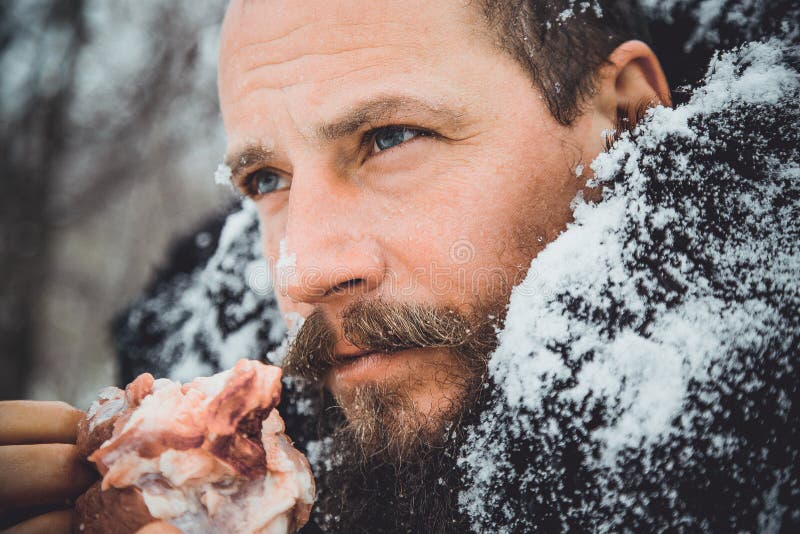Portrait of a Man with a Beard Devouring Raw Meat. Hungry Northern ...