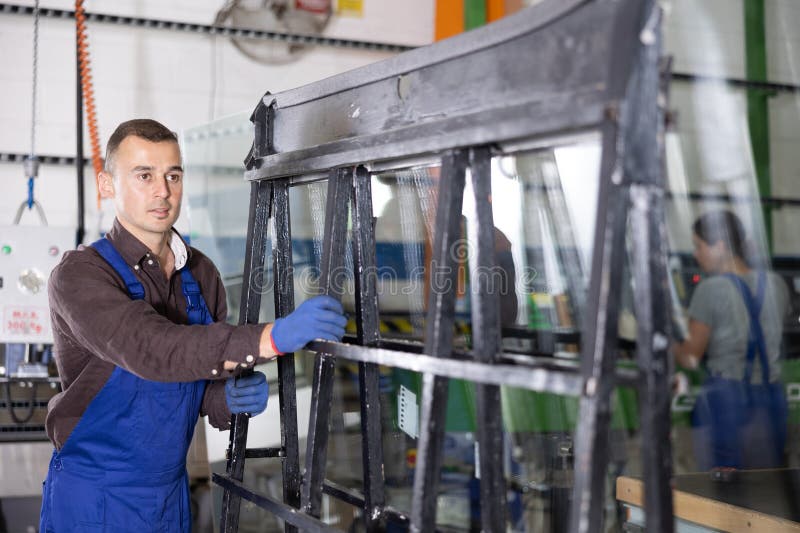Portrait of Man in Blue Overalls with Window Panes in Glass Workshop ...
