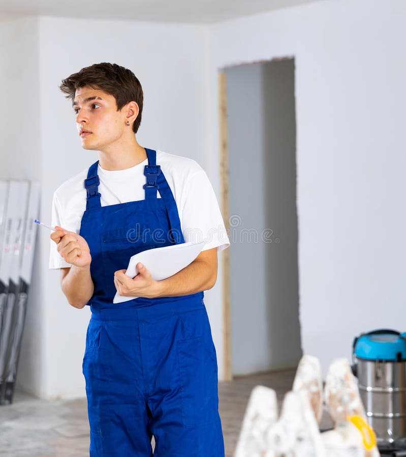 Portrait of Man Builder in Construction Overalls with Documents in ...
